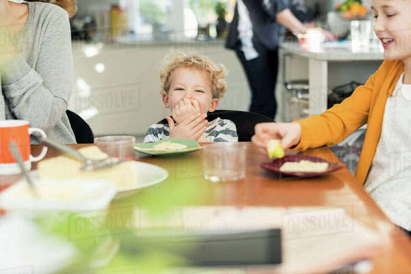 Happy family eating breakfast at home - Royalty-free Stock Photo | Dissolve