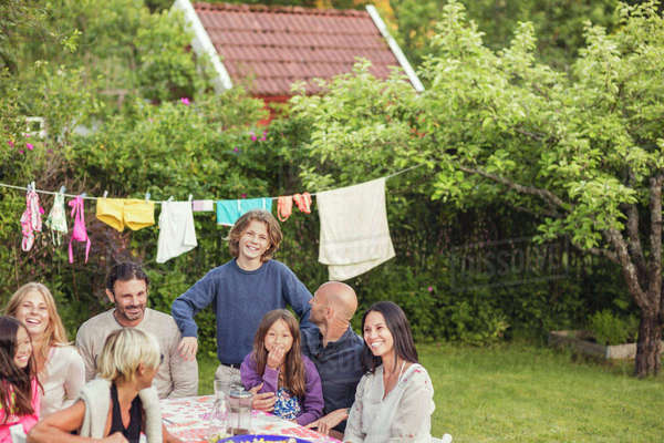 Happy family and friends during garden party in back yard - Royalty ...