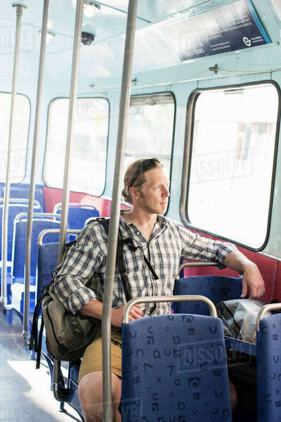 Man sitting on seat in metro train - Stock Photo - Dissolve