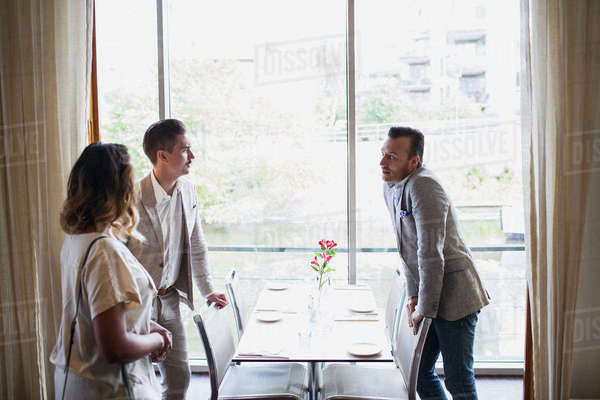 Business people standing by table against window at restaurant - Stock ...