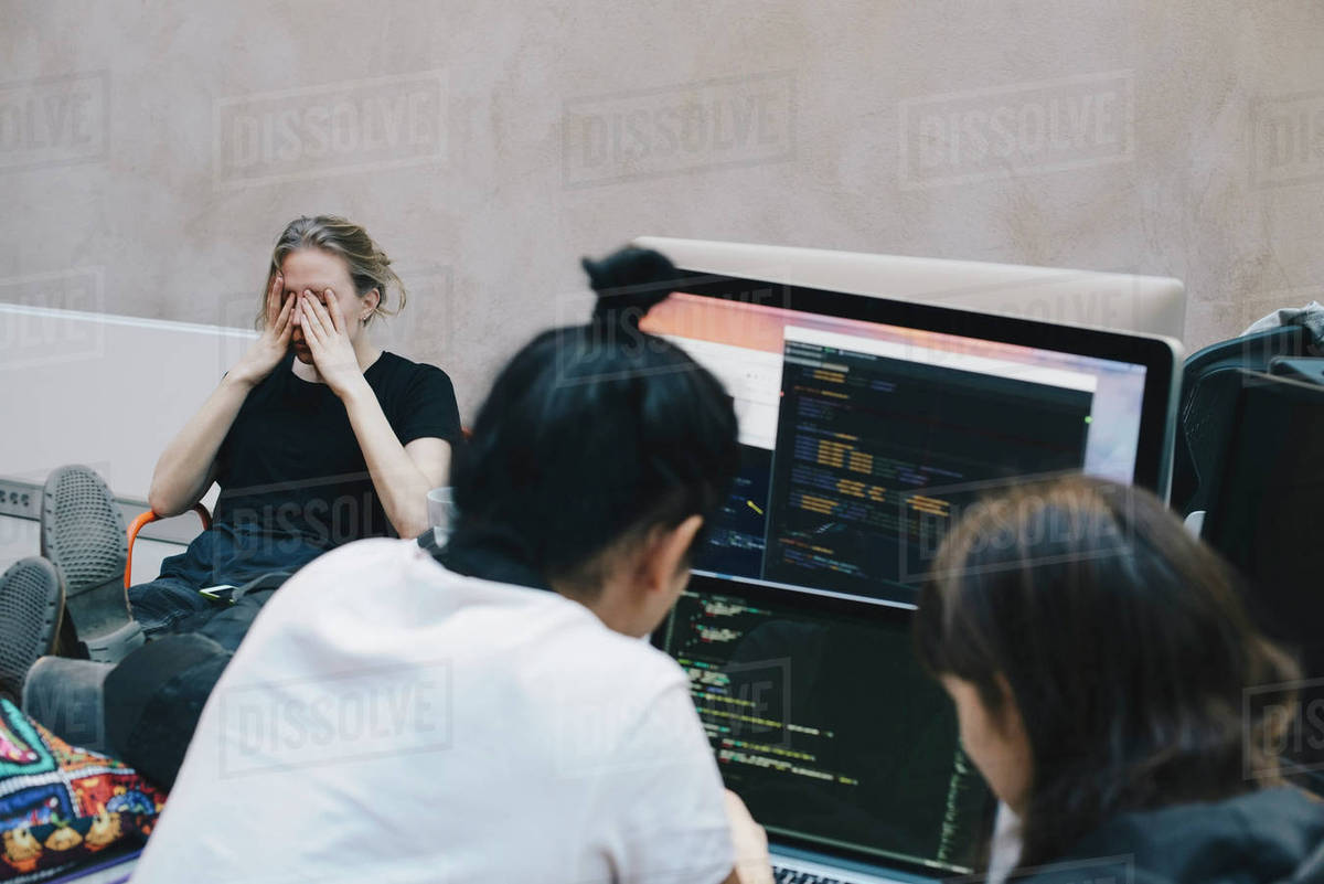 Male and female computer programmers using computer at office - Royalty ...