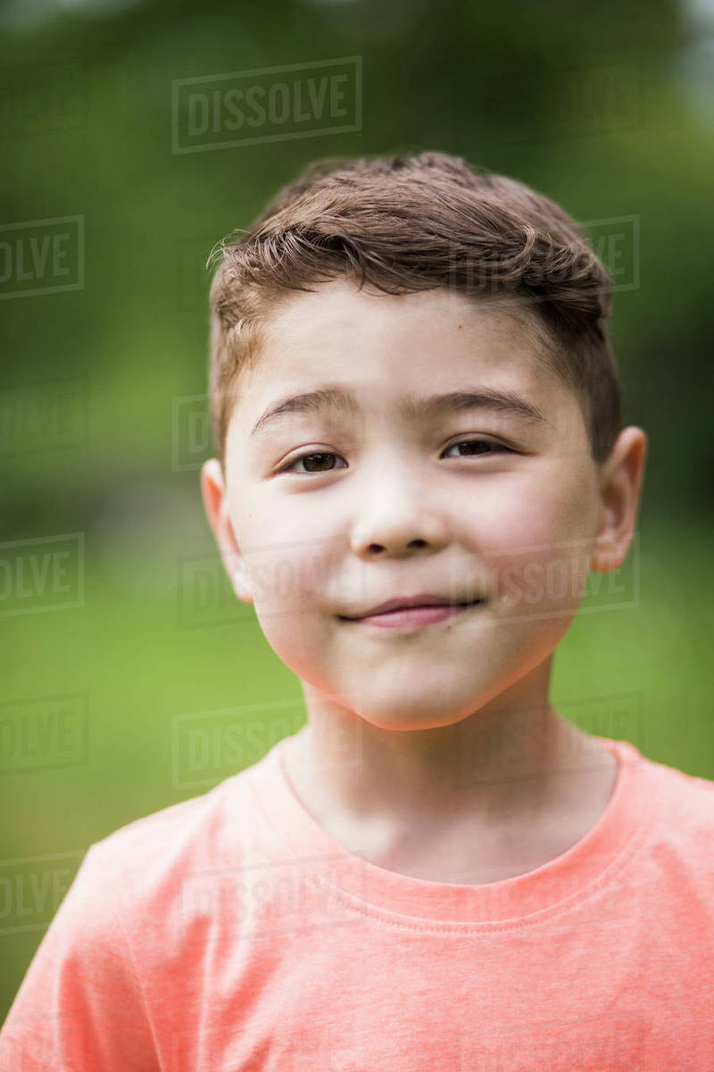 Portrait of elementary boy standing in back yard - Royalty-free Stock ...