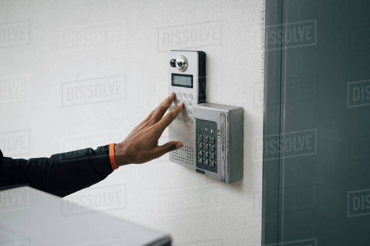 Cropped image of delivery man ringing intercom on wall - Royalty-free ...