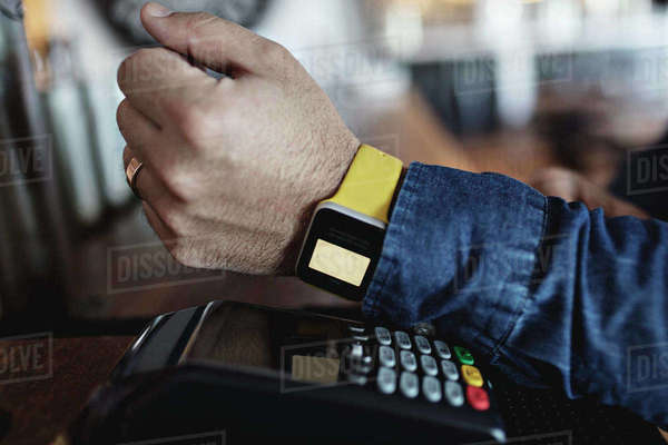 Cropped image of customer doing contactless payment through smart watch ...