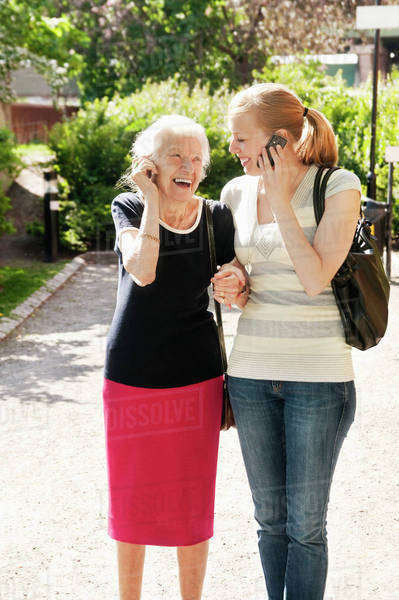 Two women talking in cellphone outside - Royalty-free Stock Photo ...