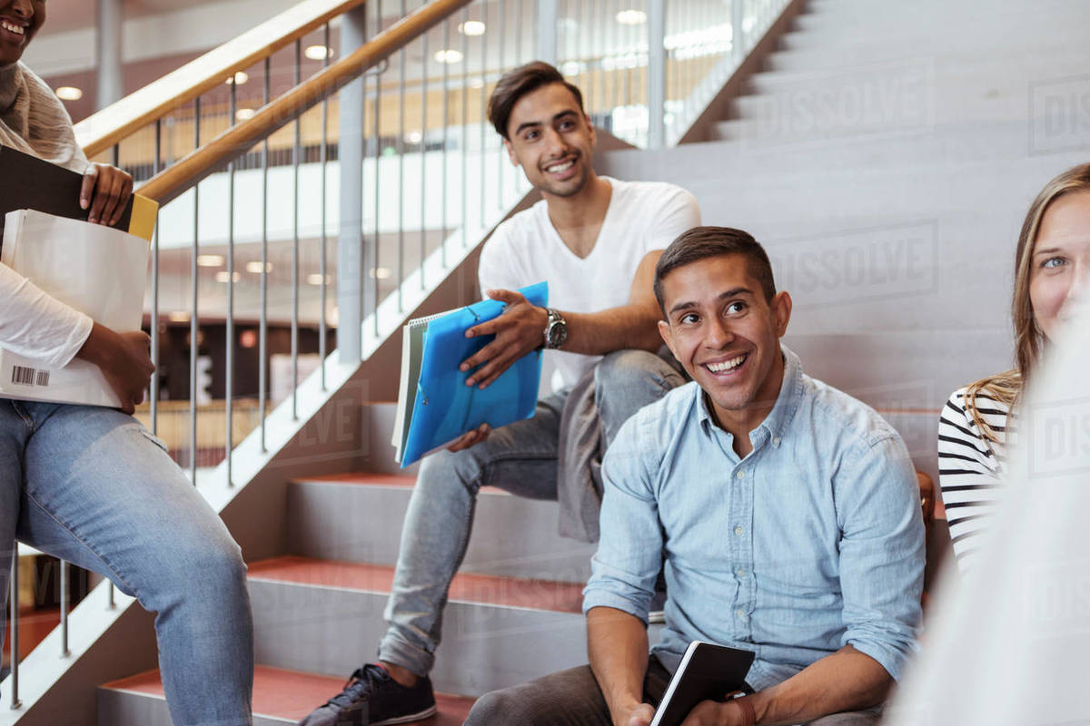Smiling high school students talking on steps at campus - Stock Photo ...