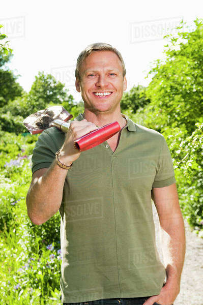 Man with spade outside - Royalty-free Stock Photo | Dissolve