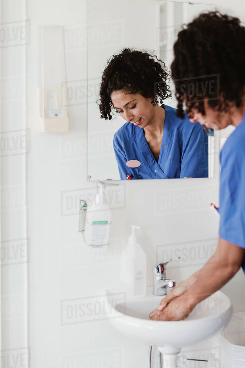 Female nurse washing hands at sink in hospital - Royalty-free Stock ...