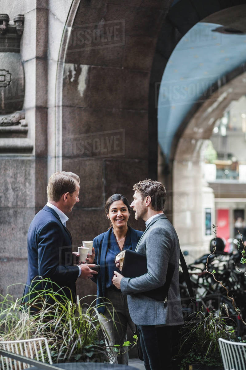 Happy business people talking at sidewalk cafe - Royalty-free Stock ...