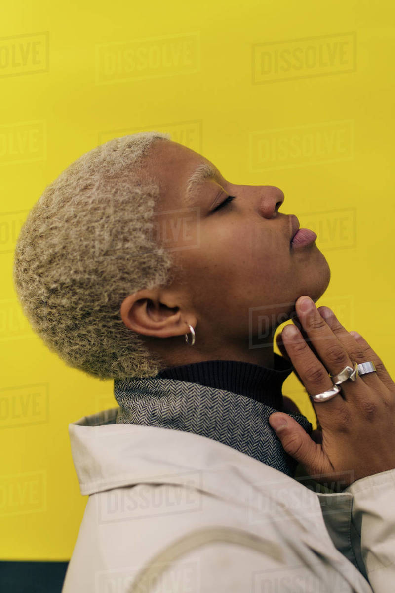 Side view of contemplating young female with eyes closed standing ...