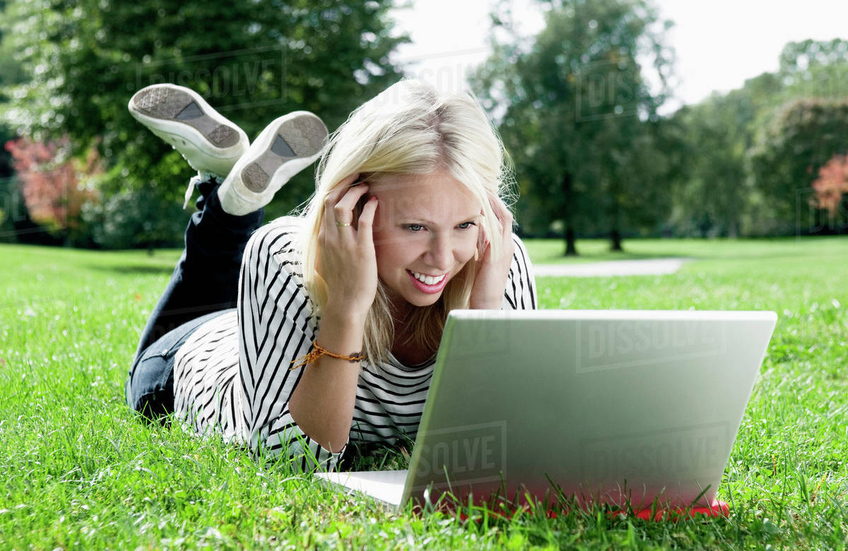 Girl on lawn with computer - Royalty-free Stock Photo | Dissolve