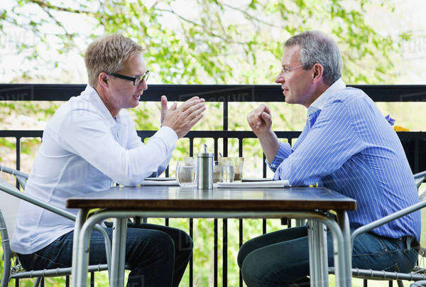 Two men eat lunch - Royalty-free Stock Photo | Dissolve