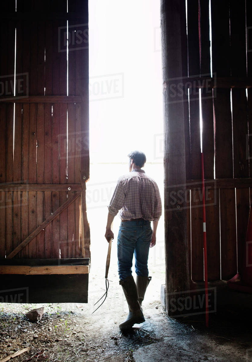 Man exit barn - Stock Photo - Dissolve