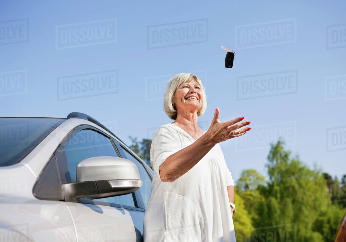 Woman throwing car keys - Royalty-free Stock Photo | Dissolve