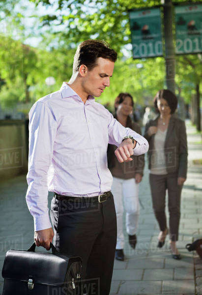 Man looking at watch - Royalty-free Stock Photo | Dissolve