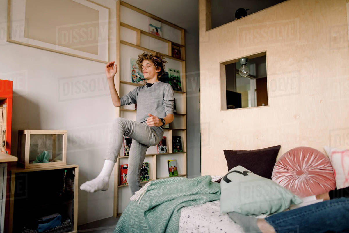 Carefree boy dancing in bedroom at home - Royalty-free Stock Photo ...