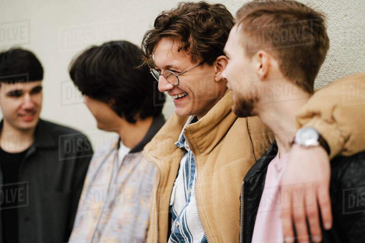 Young man laughing with arm around male friend - Royalty-free Stock ...