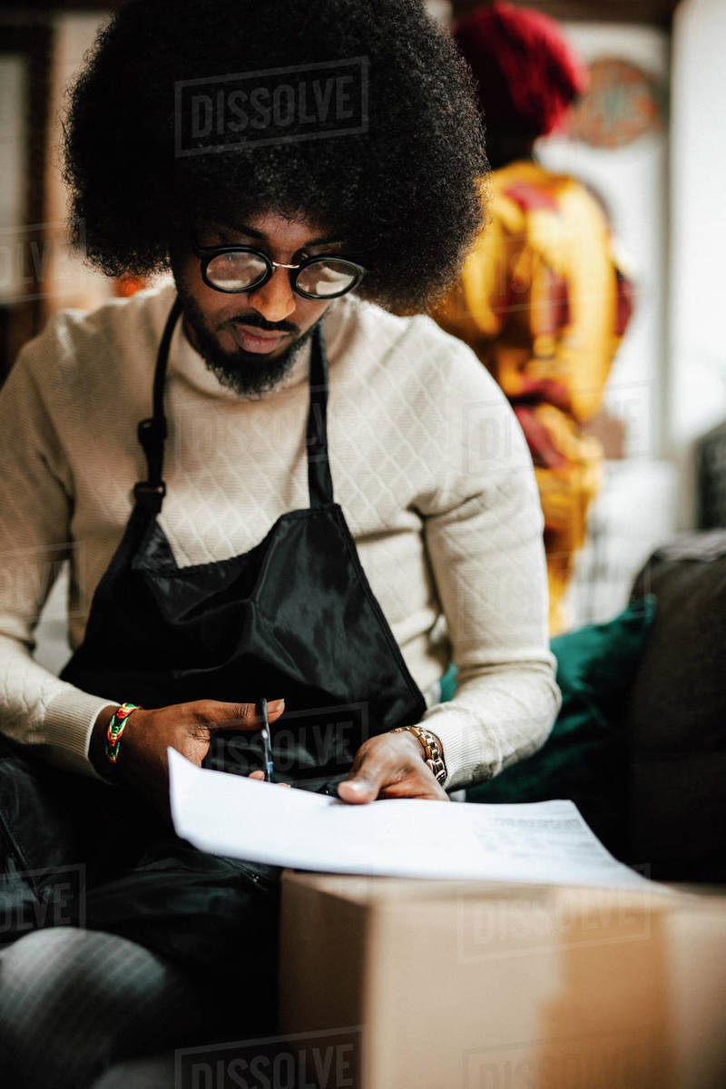 Young male barber cutting paper in hair salon - Royalty-free Stock ...