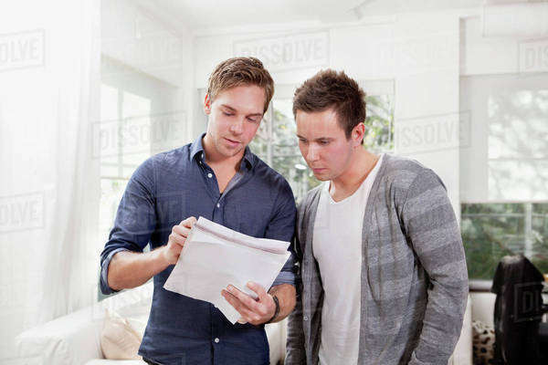 Two men looking at paper - Stock Photo - Dissolve
