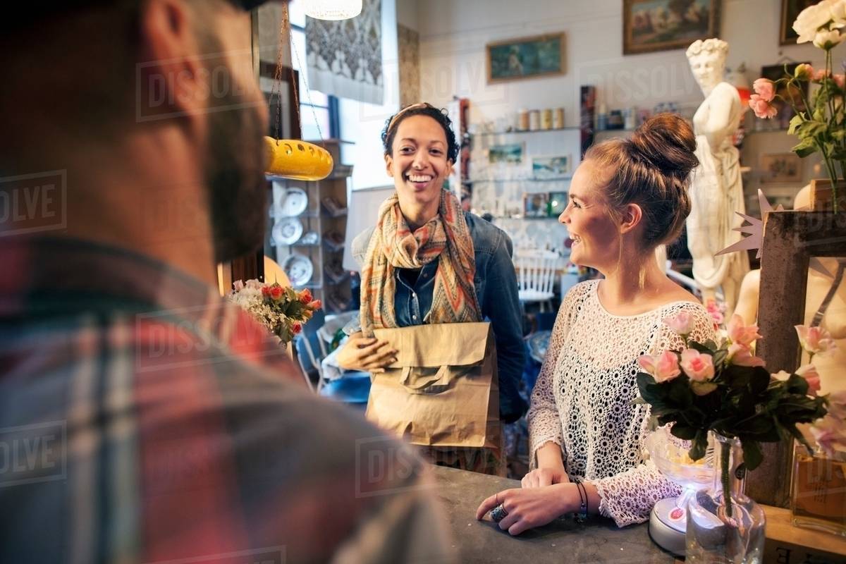 Two happy young female customers buying from vintage shop - Royalty ...