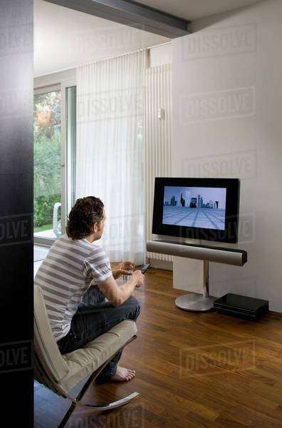 Man watching television - Royalty-free Stock Photo | Dissolve