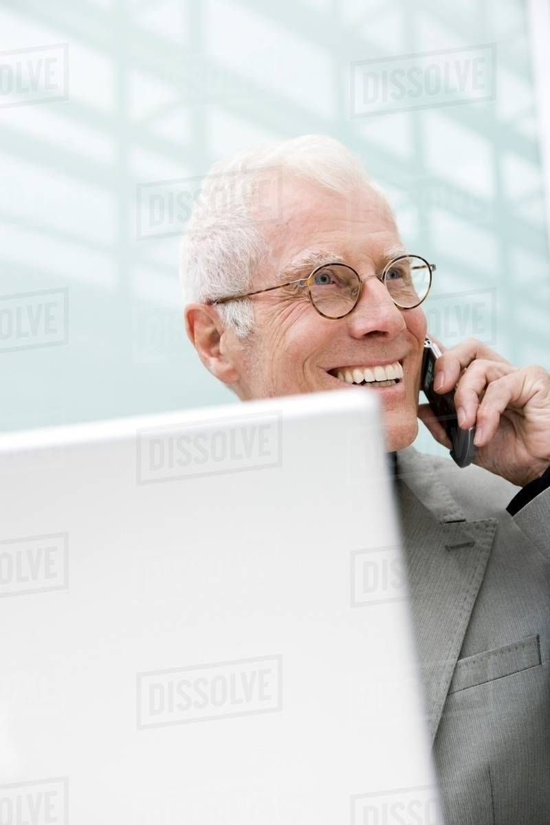 Older man using cell phone - Royalty-free Stock Photo | Dissolve