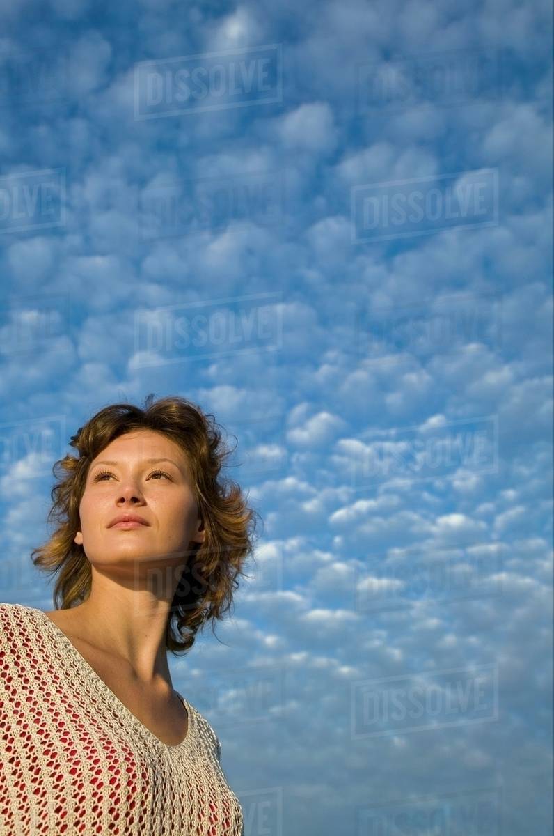 Woman and clouds in a blue sky - Royalty-free Stock Photo | Dissolve