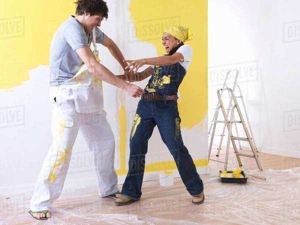 Couple messing around with paint. - Stock Photo - Dissolve