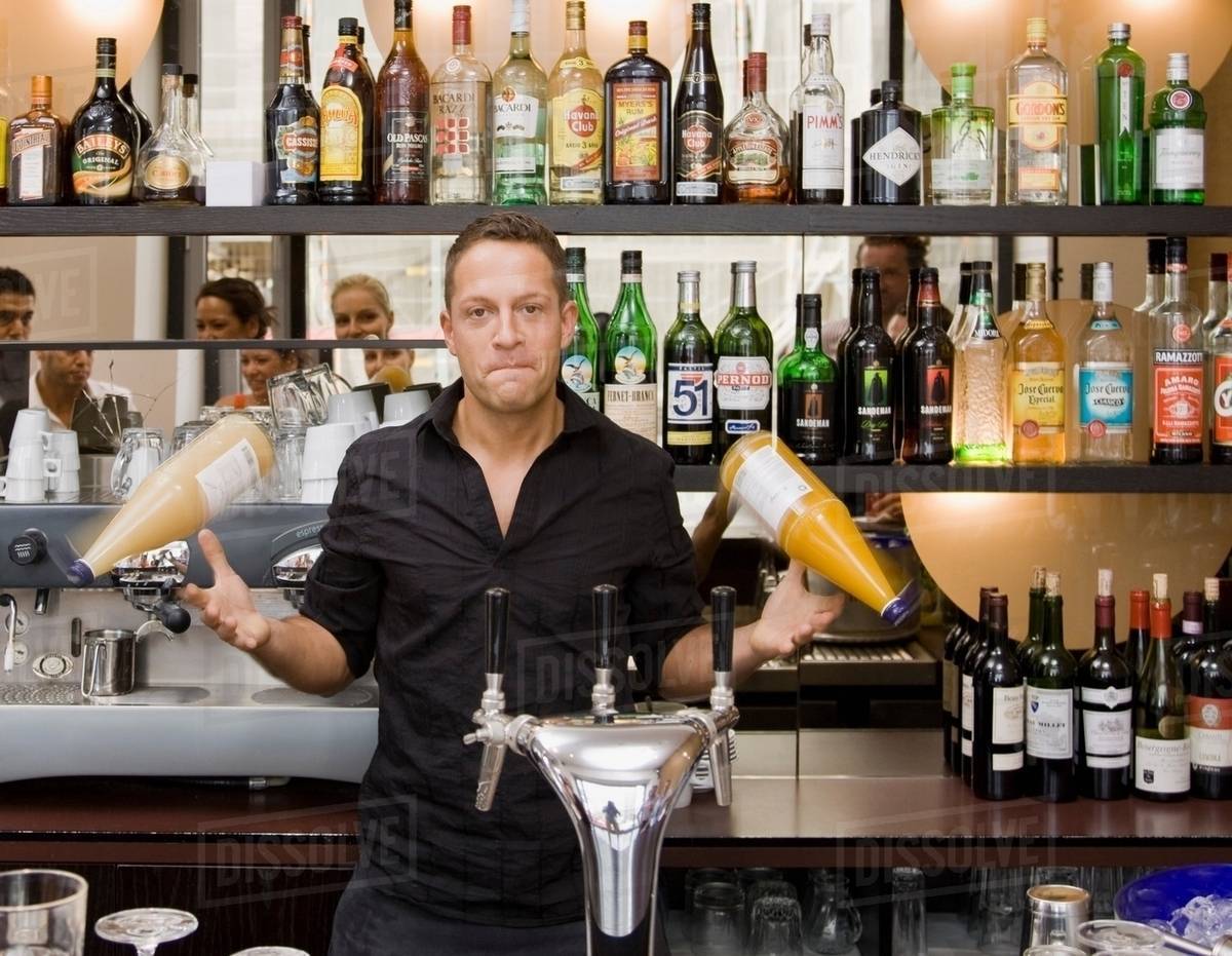 Portrait of bartender spinning drinks - Stock Photo - Dissolve