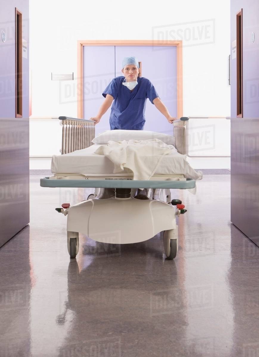 A female doctor pushing a bed - Stock Photo - Dissolve