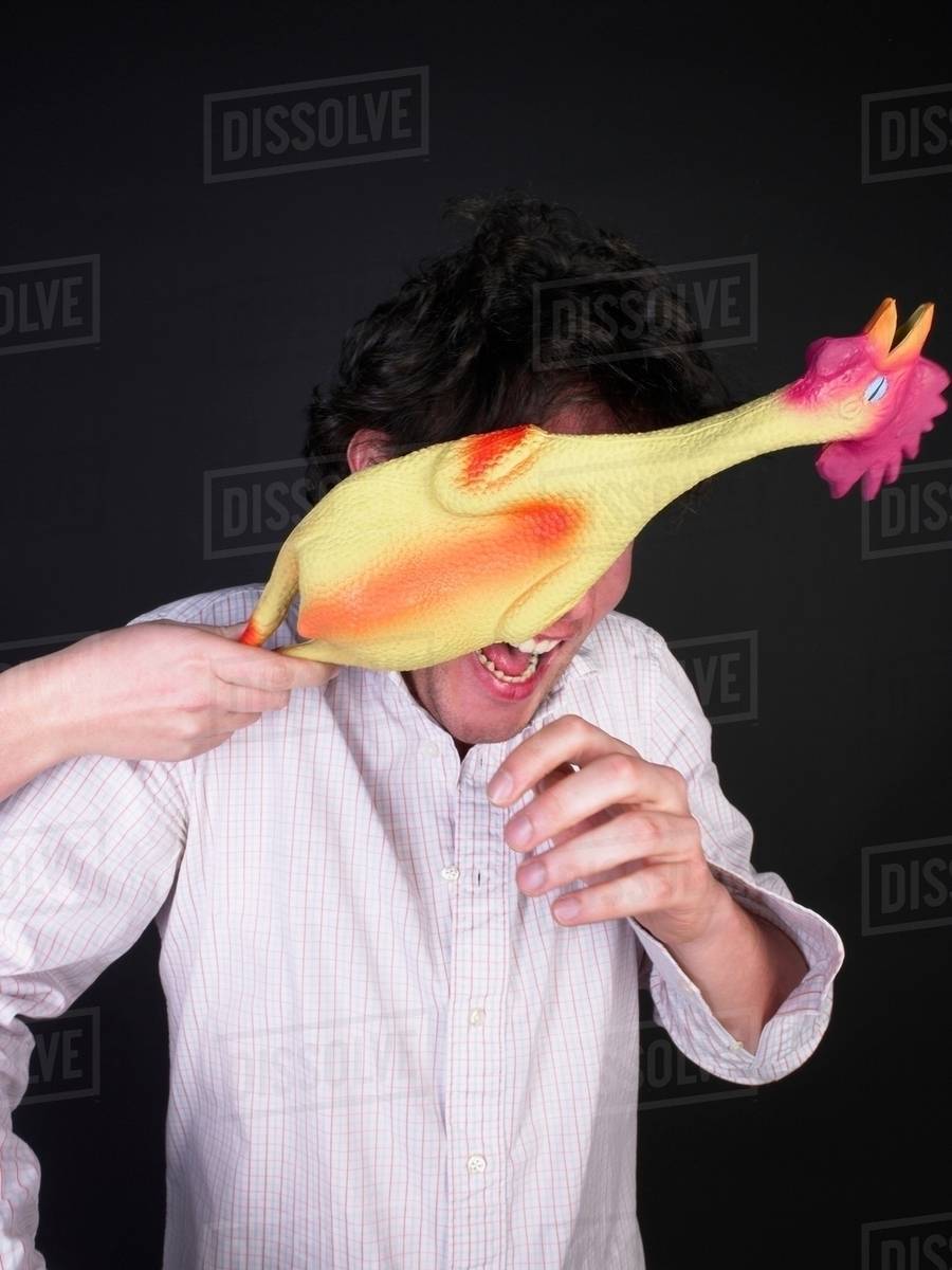 Man getting hit with rubber chicken - Royalty-free Stock Photo | Dissolve