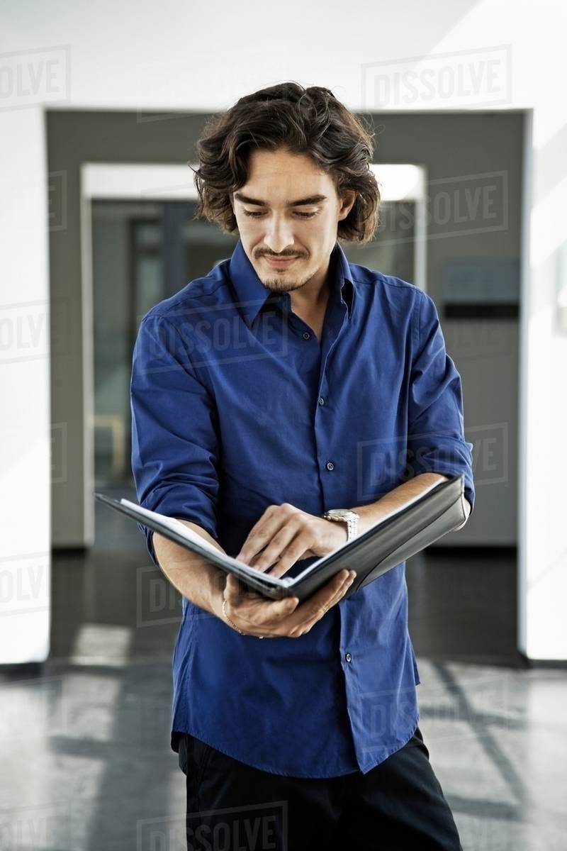 Man looking at a file - Stock Photo - Dissolve