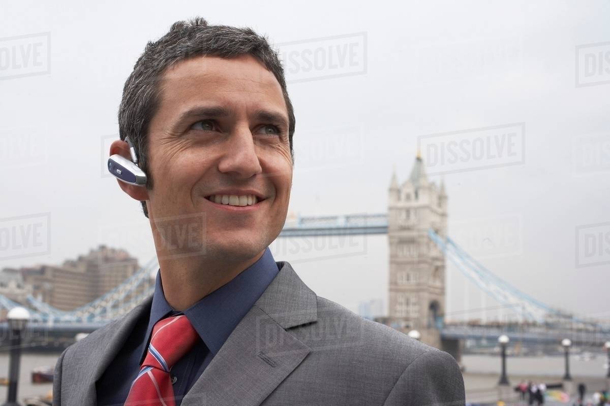 Man with bluetooth headset outside - Royalty-free Stock Photo | Dissolve
