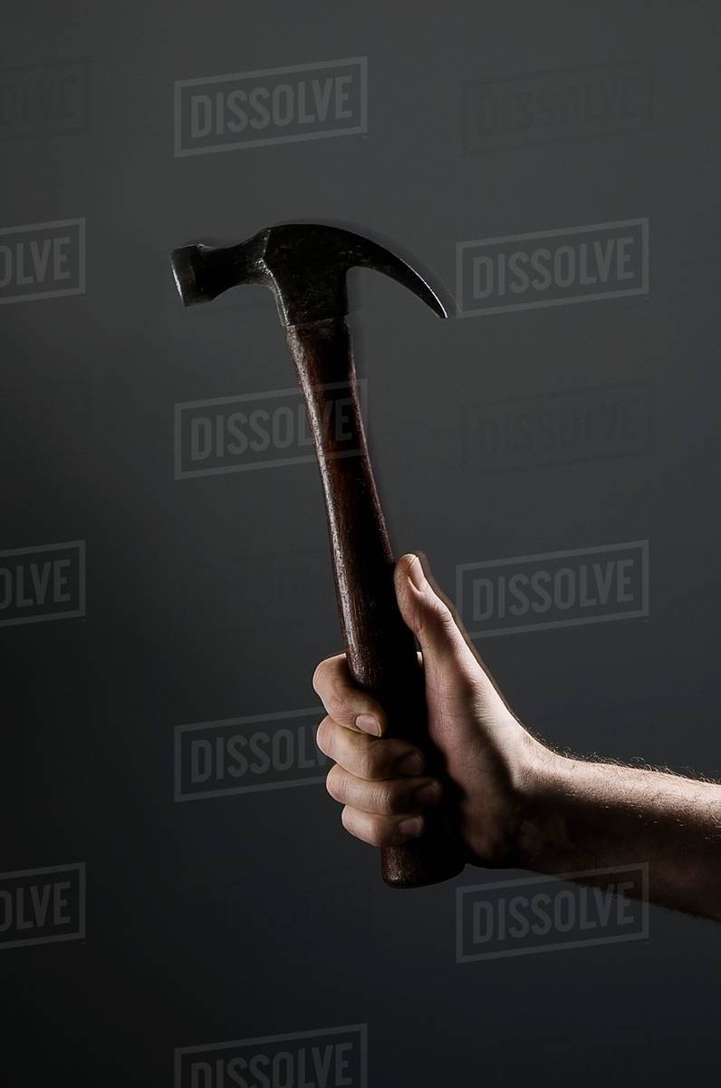 Female hand holding a hammer - Royalty-free Stock Photo | Dissolve