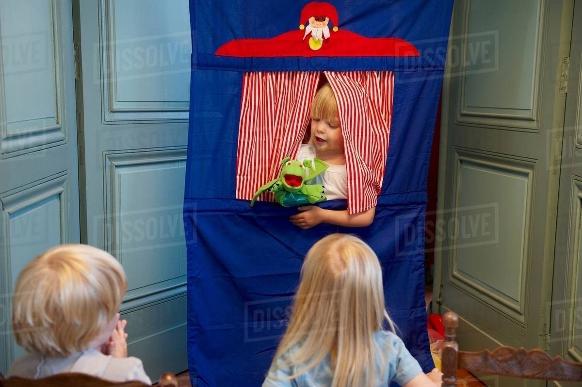 Kids watching a puppet show - Stock Photo - Dissolve