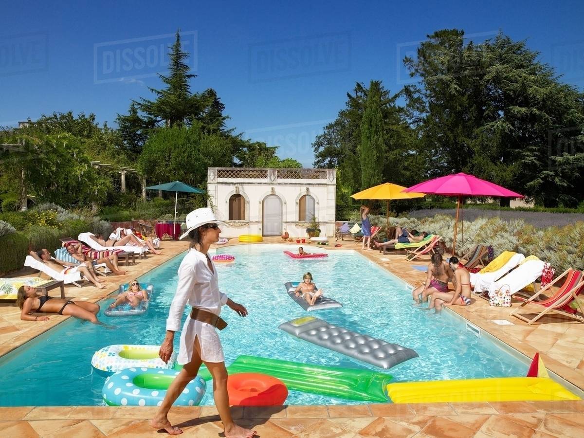 People enjoying summer around the pool - Stock Photo - Dissolve