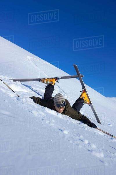 Male skier fallen over - Royalty-free Stock Photo | Dissolve