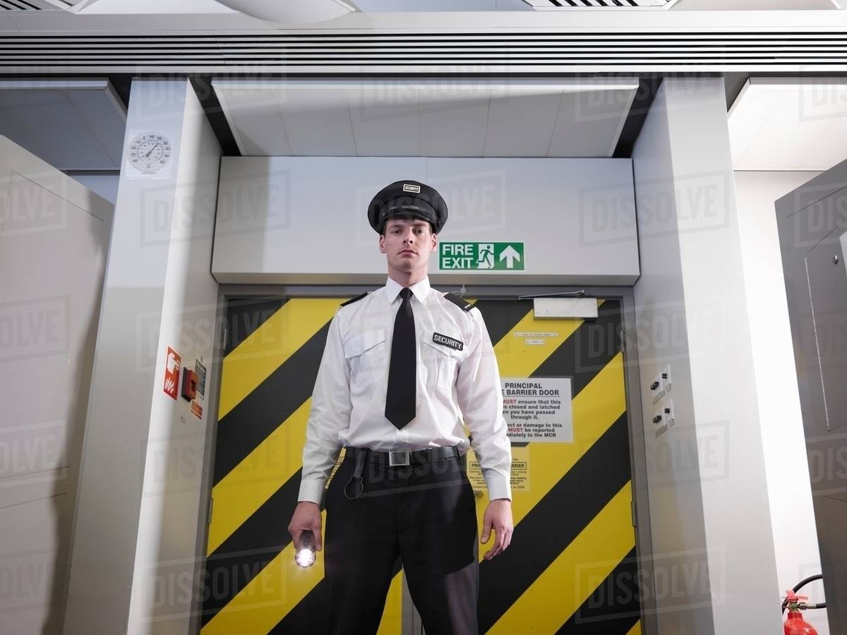 Security guard with torch - Stock Photo - Dissolve