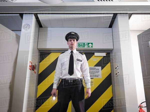 Security guard with torch - Stock Photo - Dissolve