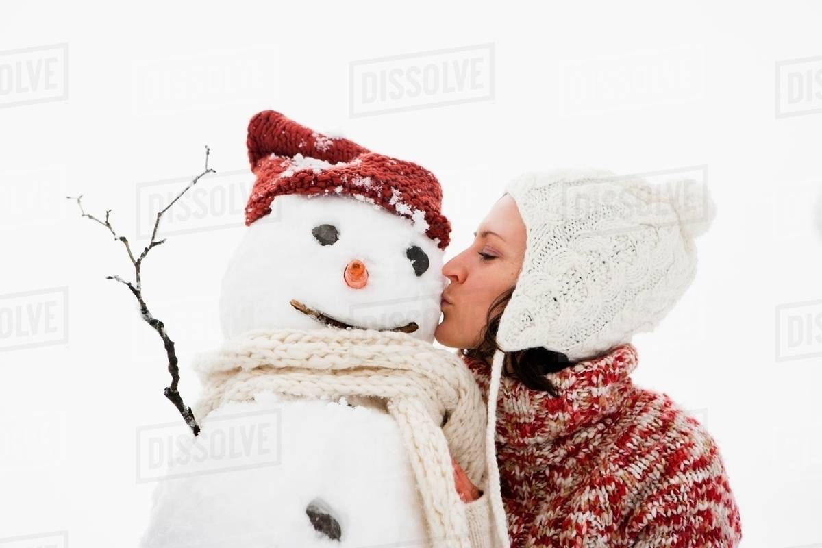 Woman kissing snowman - Royalty-free Stock Photo | Dissolve