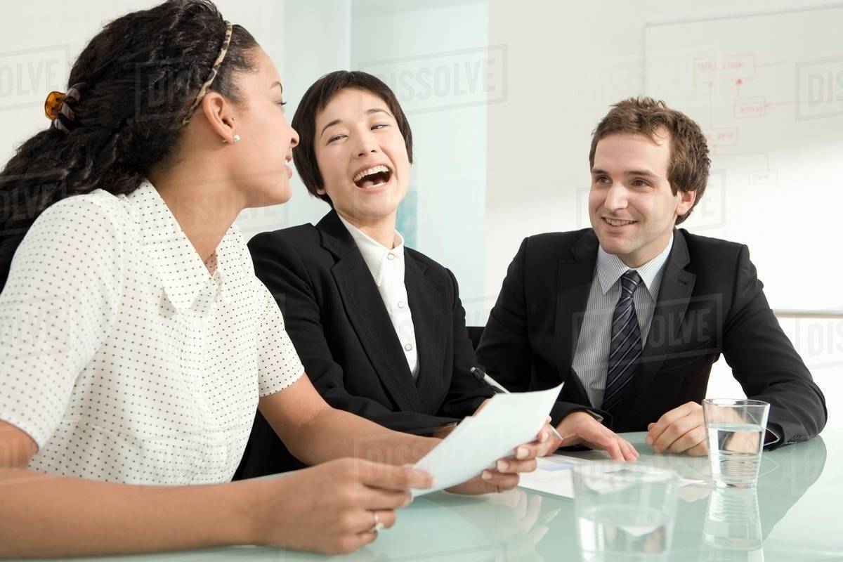 Three colleagues laughing - Stock Photo - Dissolve