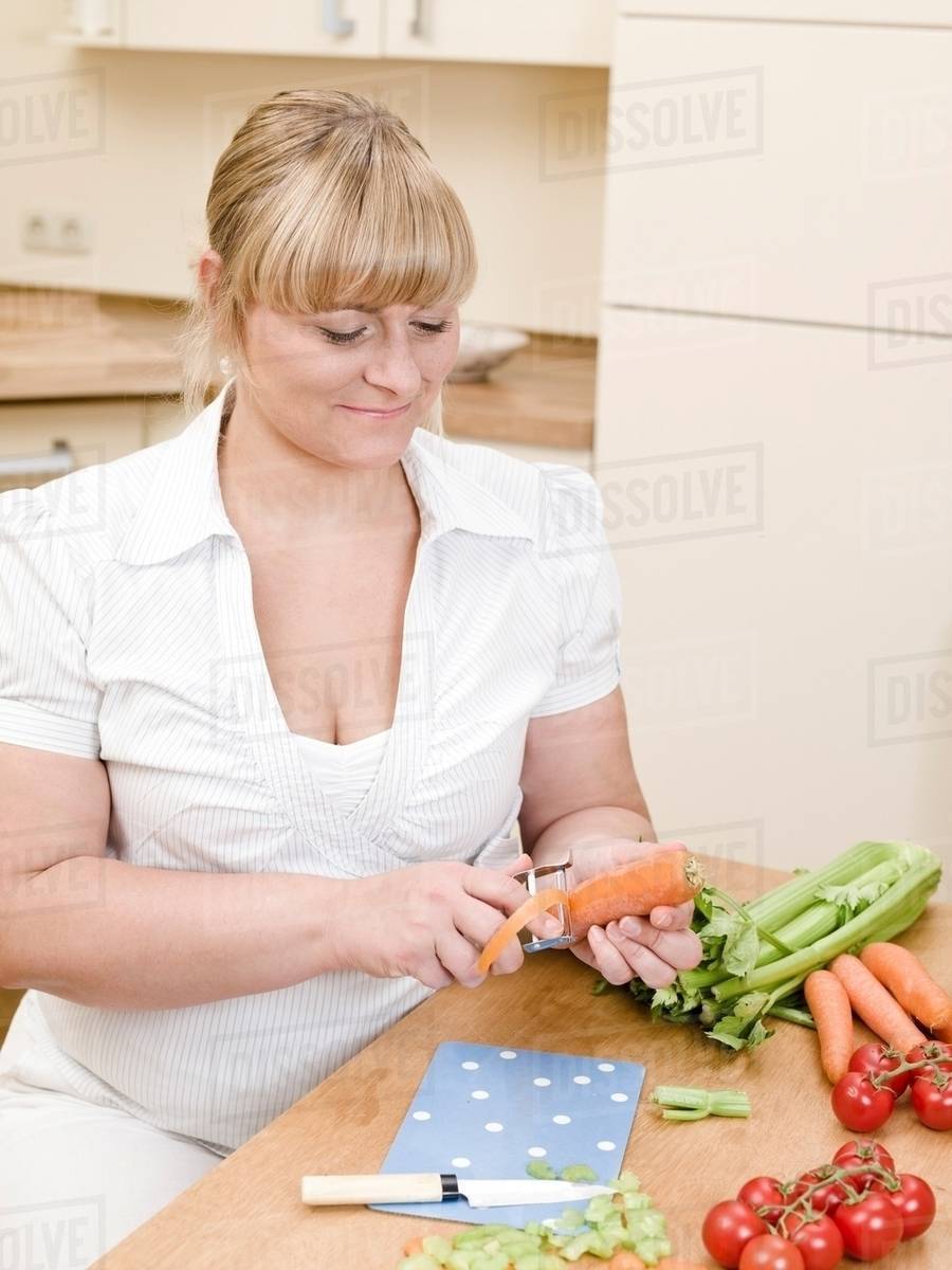 Woman cutting vegetables - Royalty-free Stock Photo | Dissolve