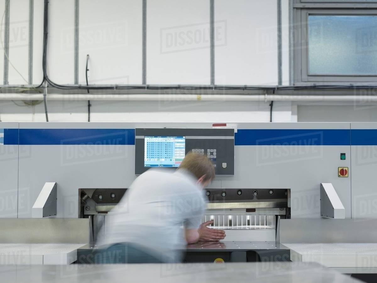 Worker Operating Printer - Stock Photo - Dissolve