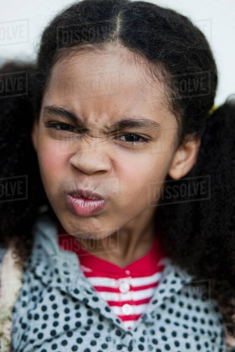 Young girl making face at viewer - Stock Photo - Dissolve