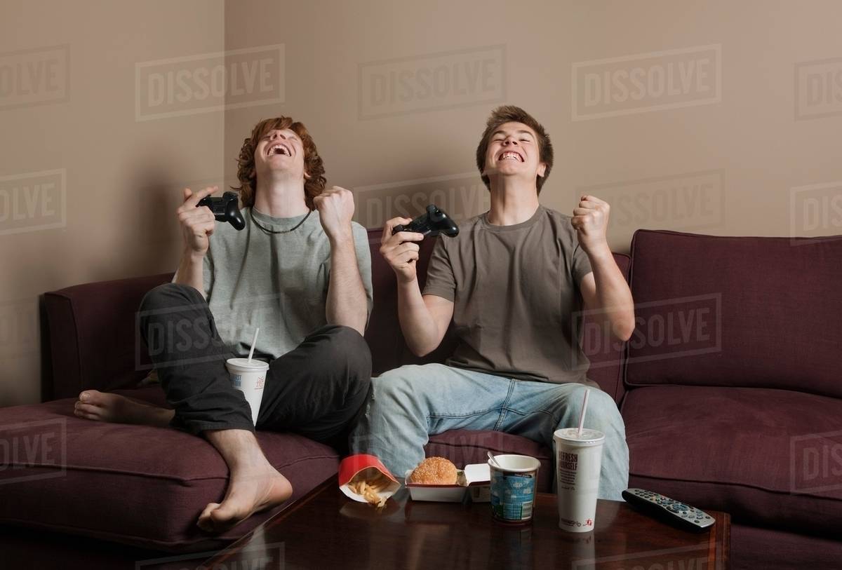 Boys playing video game - Stock Photo - Dissolve