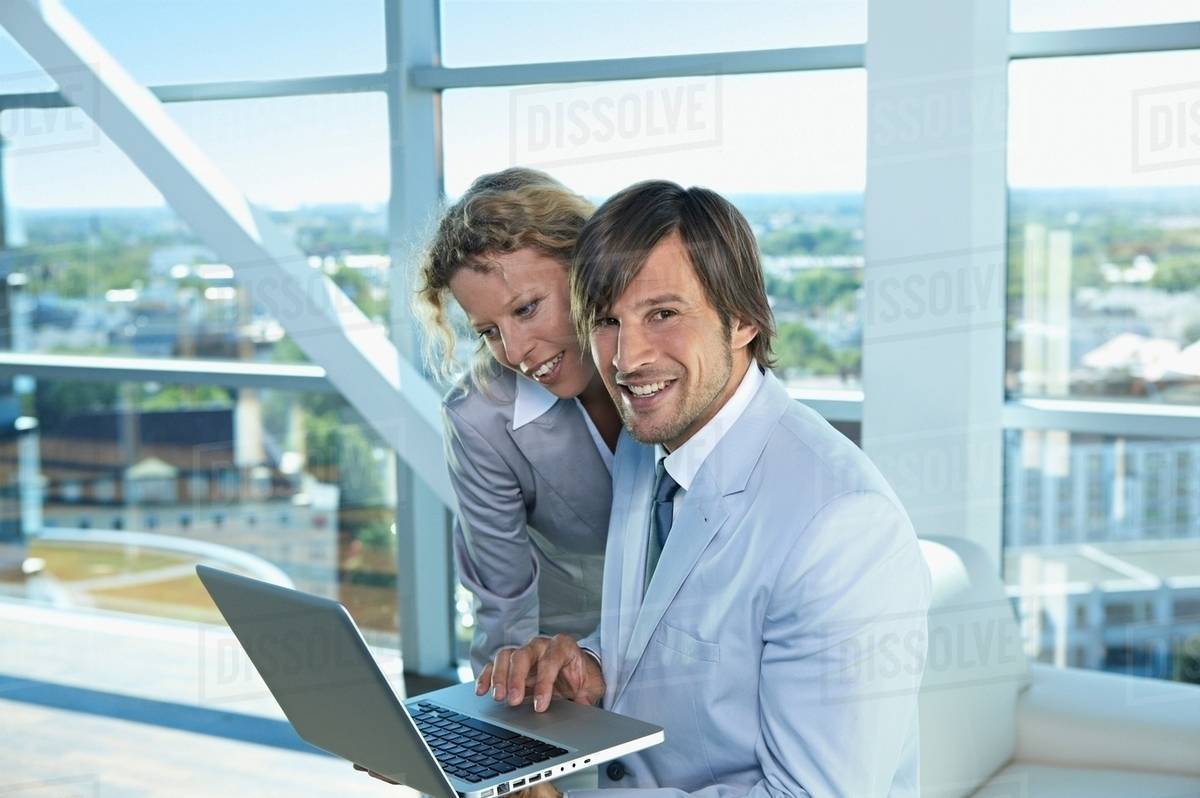 Business man and woman with computer - Stock Photo - Dissolve