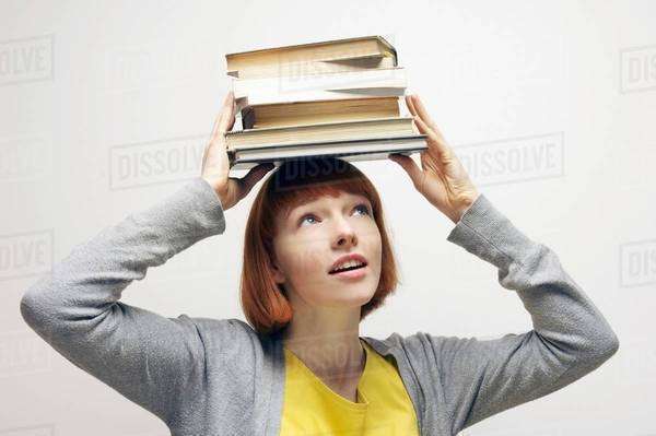 Woman balancing books on head - Royalty-free Stock Photo | Dissolve