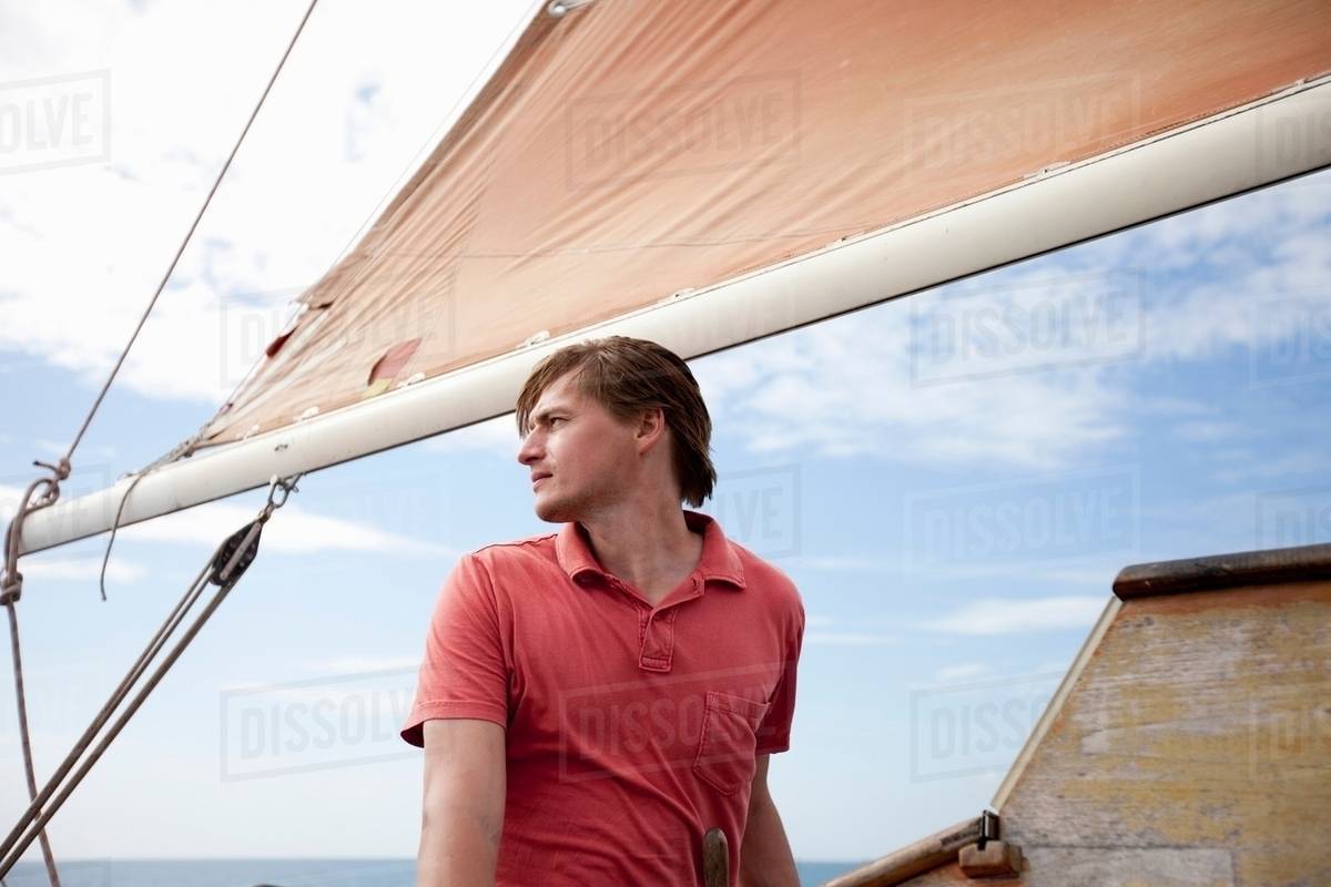 Man standing under a sail - Royalty-free Stock Photo | Dissolve