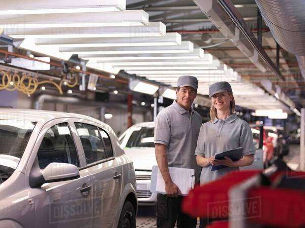 Car Workers With Completed Cars - Stock Photo - Dissolve