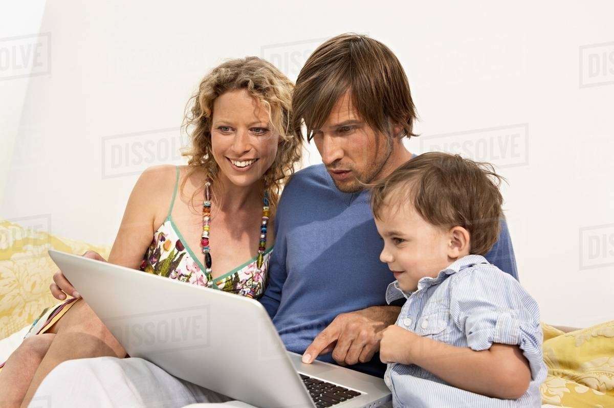 Family using computer - Royalty-free Stock Photo | Dissolve